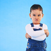 Angry, child and arms crossed with tantrum in studio with mockup space ...