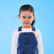 Tantrum, attitude and portrait of child on blue background with upset ...