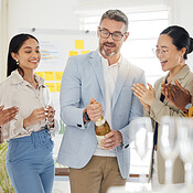 Success, champagne and party with business people in office for winner ...