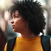Profile of a female journalism student standing on campus outside. Face ...