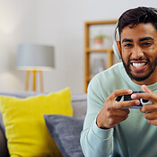 Gaming, winner and esports with a man in the living room of his home ...