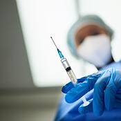 Needle in hand, medicine and doctor person, healthcare and low angle ...