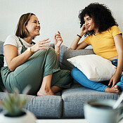 Women, friends talk and conversation in a home with gossip, discussion ...