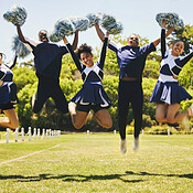 Cheerleader team portrait, smile and jump for performance on field ...