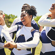 Cheerleaders, grass field and champion with celebration, smile and ...