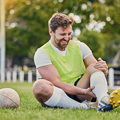 Football, man and knee pain on grass field, inflammation and bruise ...
