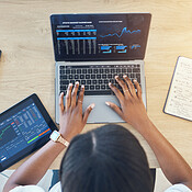 Person, hands and laptop, stock market and trading with tablet ...