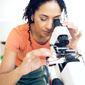 Optometrist, woman on microscope and glasses for calibration, exam and ...