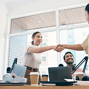 Communication, smile and podcast people shaking hands for hello ...