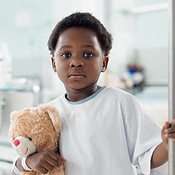 African child, sick in hospital and teddy bear for healthcare, wellness ...