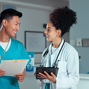 Doctor, hospital and chart for discussion, colleague and tablet for ...