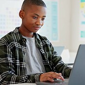 Teenager child, laptop and education at school with research, coding or ...