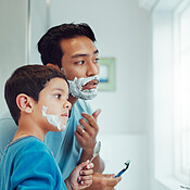 Shaving cream, child and father teaching in bathroom, family home or ...