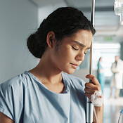 Sad, breathing and a woman with an iv drip at hospital for medicine ...