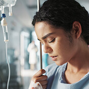 Sad, breathing and a woman with an iv drip at hospital for medicine ...