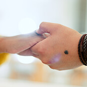Couple, closeup and holding hands in home together for support, bonding ...