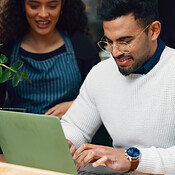 Waitress, laptop and coffee shop man, client, remote work person typing ...
