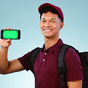 Delivery man, phone and green screen in studio with smile, mockup space ...
