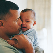 Hug, comfort and father with crying baby in a nursery with care ...