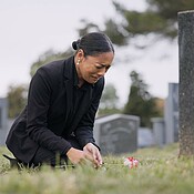 Sad woman, graveyard and crying with rose by tombstone in mourning ...