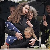 Funeral, family hug and sad people with grief support, goodbye service ...