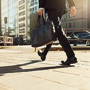 Legs, bag and business person walking, worker travel or commute to work ...