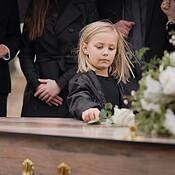 Death, grief and girl at funeral with flower on coffin, family and sad ...