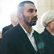 Sad, man and face closeup with depression at a funeral in church for ...