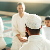 Islam, discussion and group of men in mosque with child, mindfulness ...