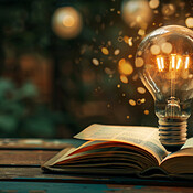 Book, light bulb and learning for ideas, growth and story development ...