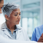Healthcare, women and doctor with discussion and communication about ...