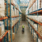 Warehouse, shipping and person walking in a distribution, freight and ...