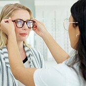 Vision, optometrist and help customer with glasses for eye health ...