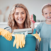 Cute cheerful little girl helping her mother clean at home. Happy ...