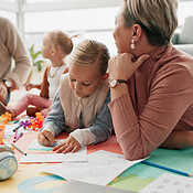 Parents, children and drawing for education on floor with family ...