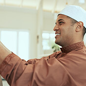 Muslim family, father and son dressing in home, happy and prayer ...