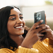 Girl, connection and smartphone in home for scroll, typing and text ...