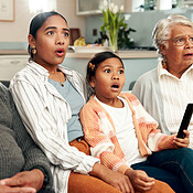 Family, shock and couch in living room, movie and streaming with ...