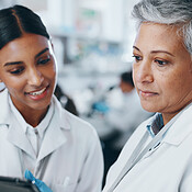 Tablet, women and scientists in laboratory with data for pharmaceutical ...