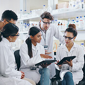 Tablet, science team and people learning for cancer cure, help or ...