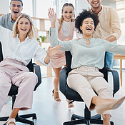 Happy corporate colleagues having fun and being playful in an office ...