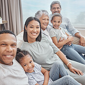 Happy and affectionate young mixed race family of six taking a selfie at home. Married couple ...