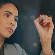 Business woman, writing and sticky note for planning, workflow or ...