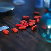 Drugs, addiction and pills on table in apartment with opioid crisis ...