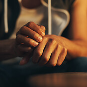 Anxiety, hands and withdrawal with person in living room of home for ...