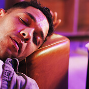 Drugs, overdose and person on sofa with sleep, health risk and narcotic ...