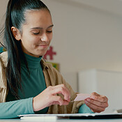 Note, message and education with girl in classroom for learning, secret ...