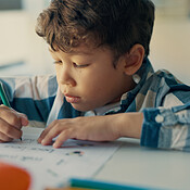 Boy, child and writing notes in classroom for education, learning and ...