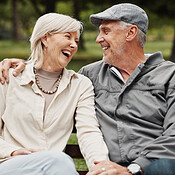 Senior couple, hug and laughing in park for bonding, conversation and commitment together ...