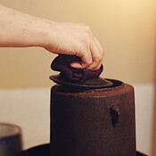 Hand, Japanese tea and teapot in home, traditional and matcha with ...